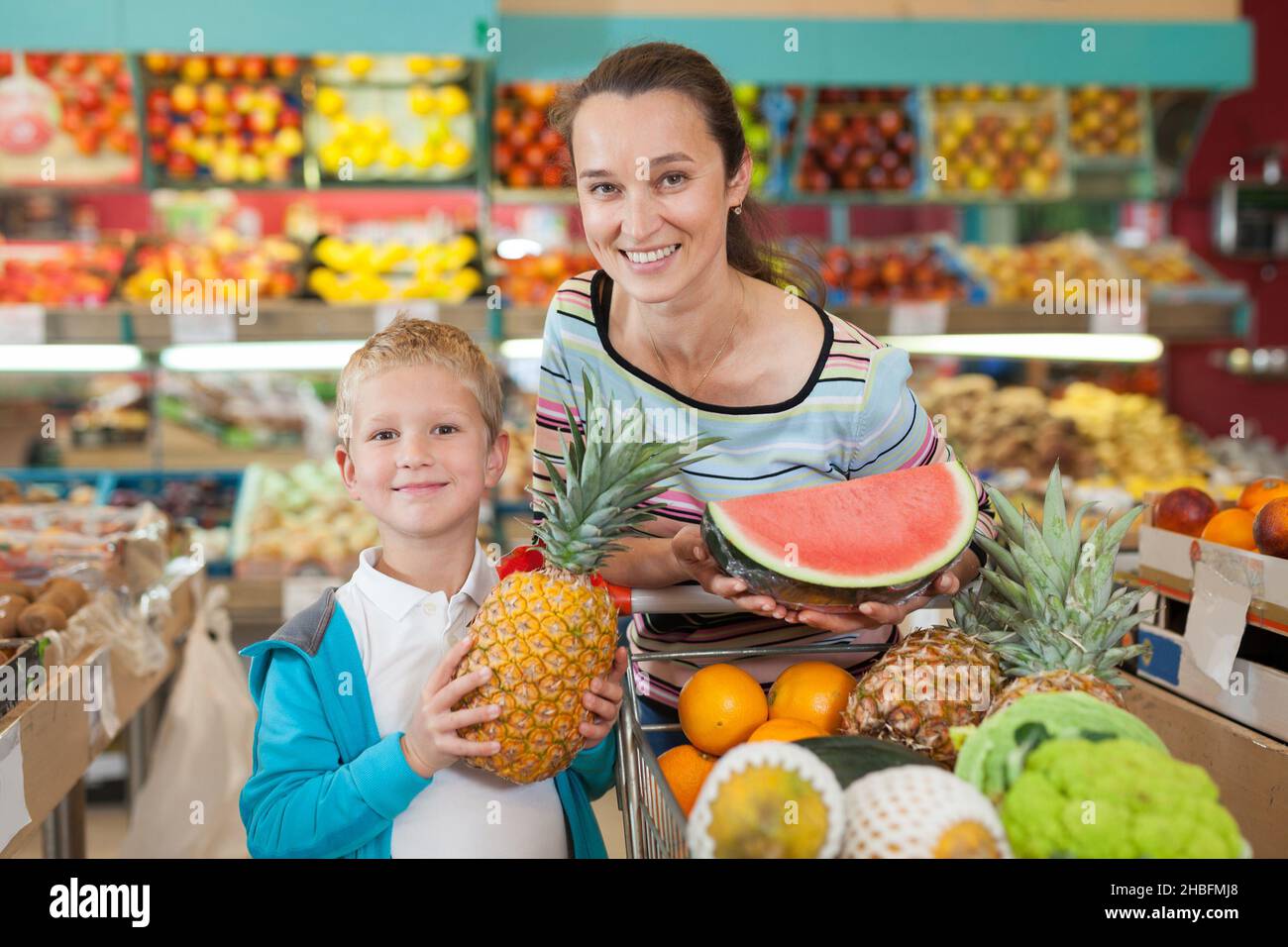 Boy with mother choosing fruits Stock Photo - Alamy