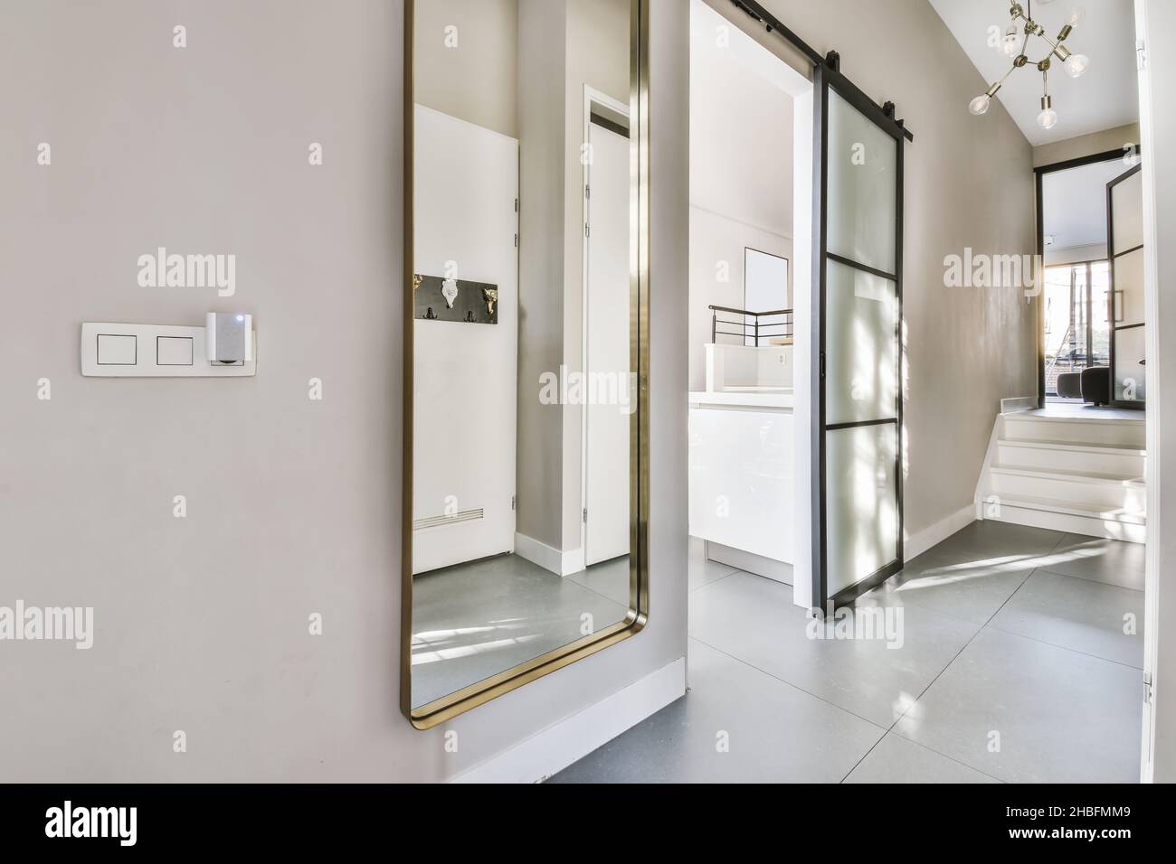 An elegant corridor with a large full-length mirror Stock Photo - Alamy