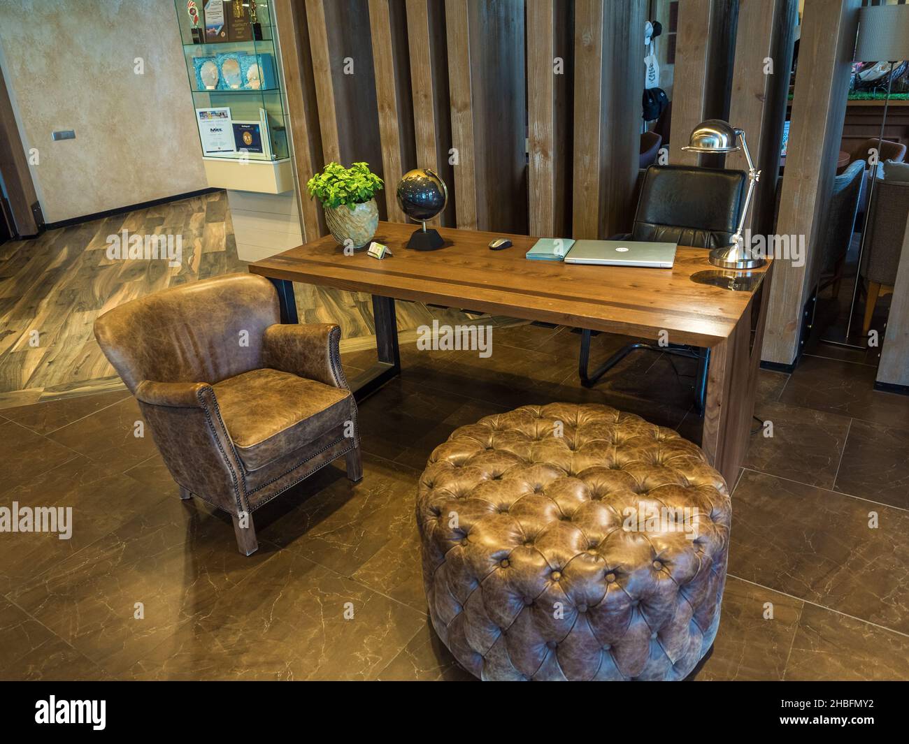 Russia, Sochi 04.08.2019. Beautiful leather armchair and pouf and desk ...