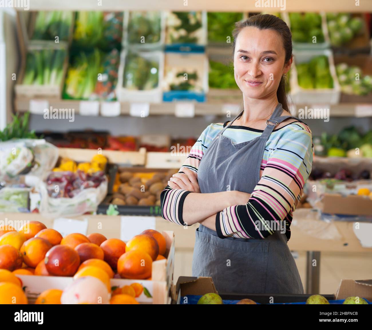 Happy woman store worker in supermarket Stock Photo - Alamy
