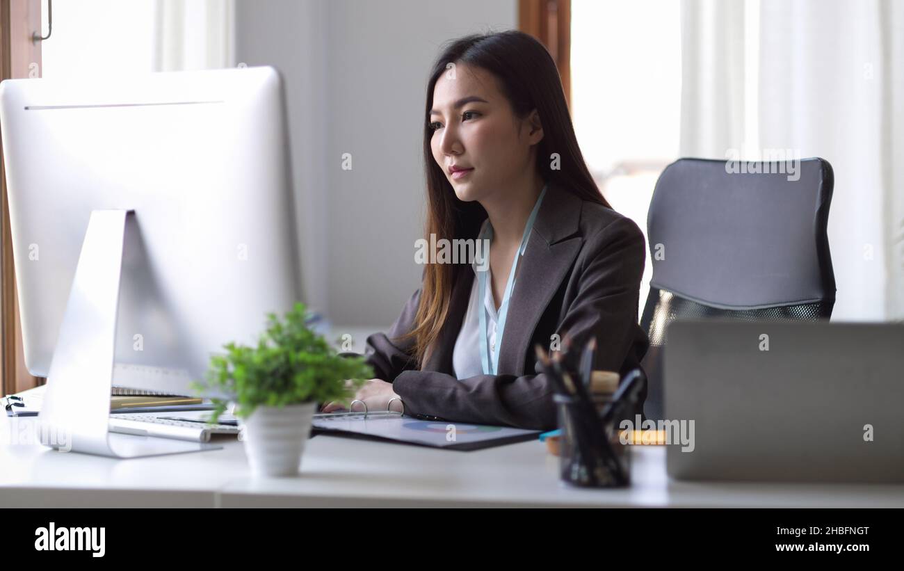 A professional female manager focused her attention on her work at her ...