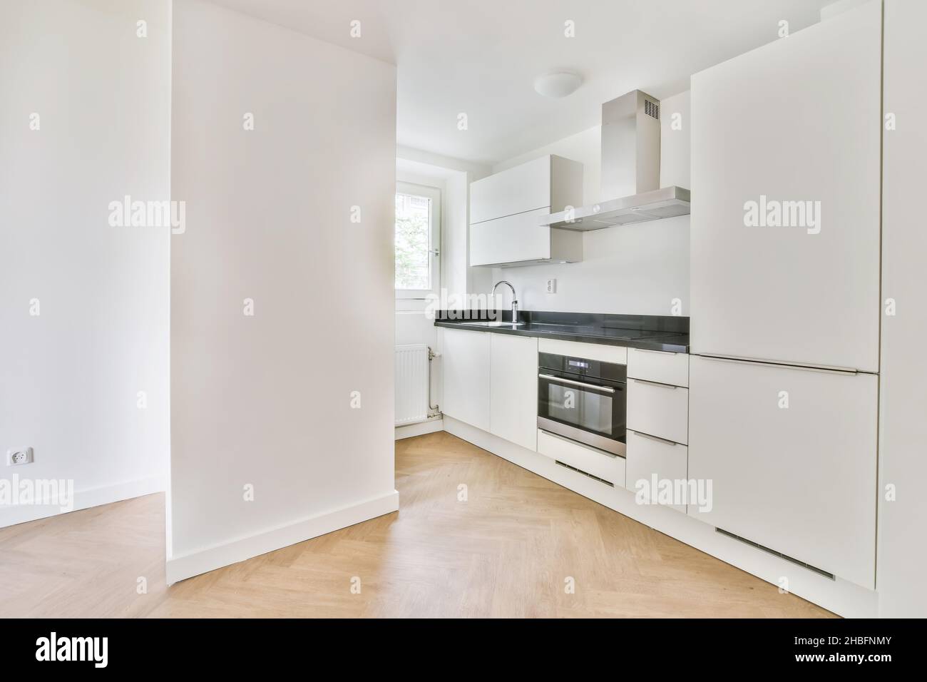 Cozy room with an oblong kitchen in a modern style Stock Photo - Alamy