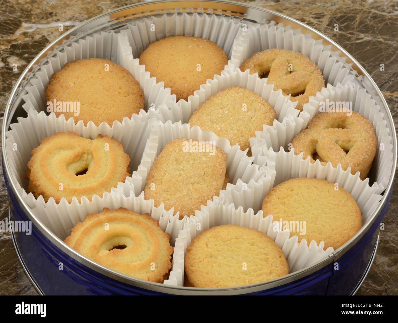 Butter shortbread cookies in paper cups in round cookie tin Stock Photo ...