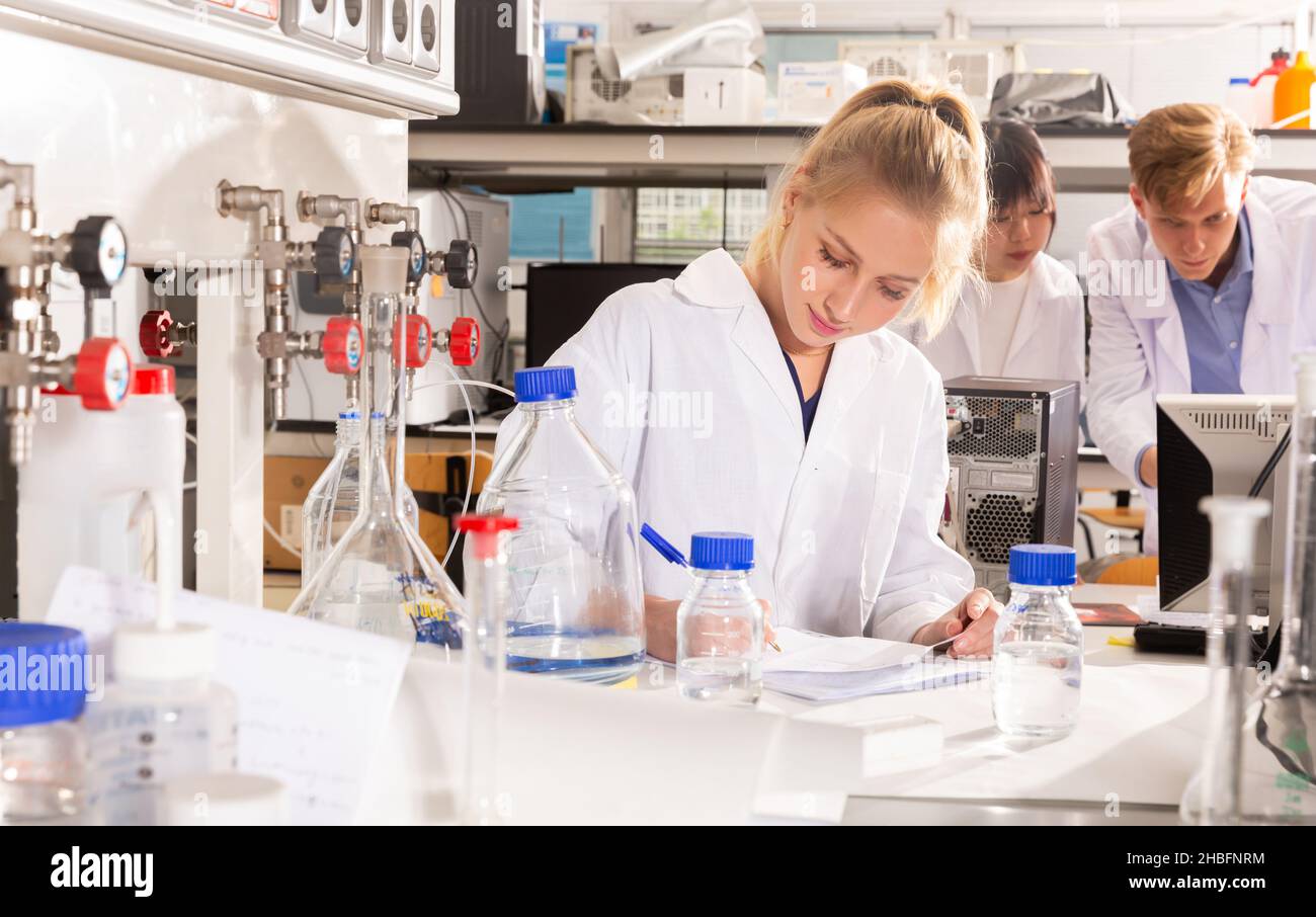 Female student recording results of experiments Stock Photo - Alamy