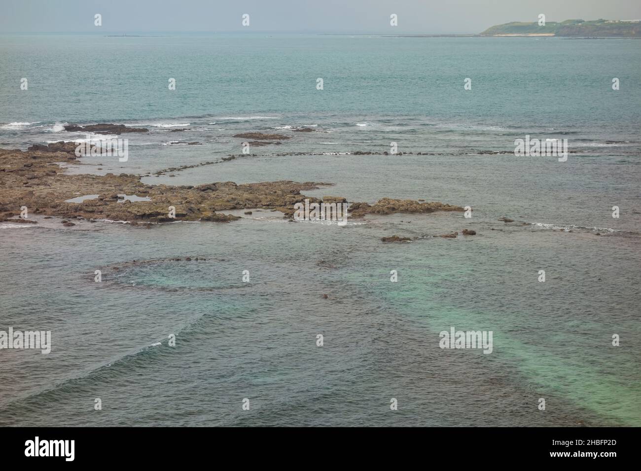 Twin Hearts Stone Weir cover in water at Penghu island, Taiwan Stock ...