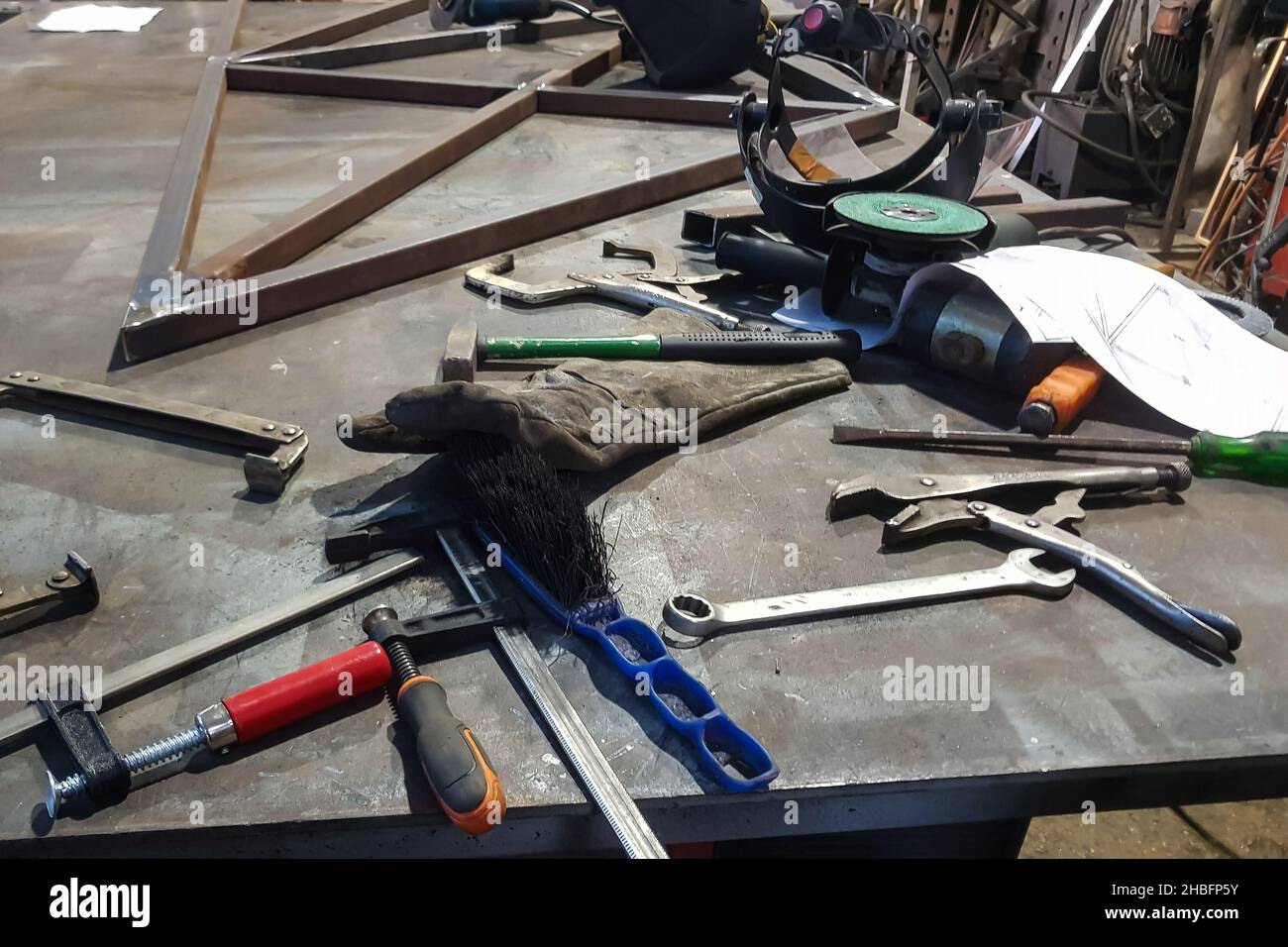 the workplace of a locksmith welder with different tools at the factory ...