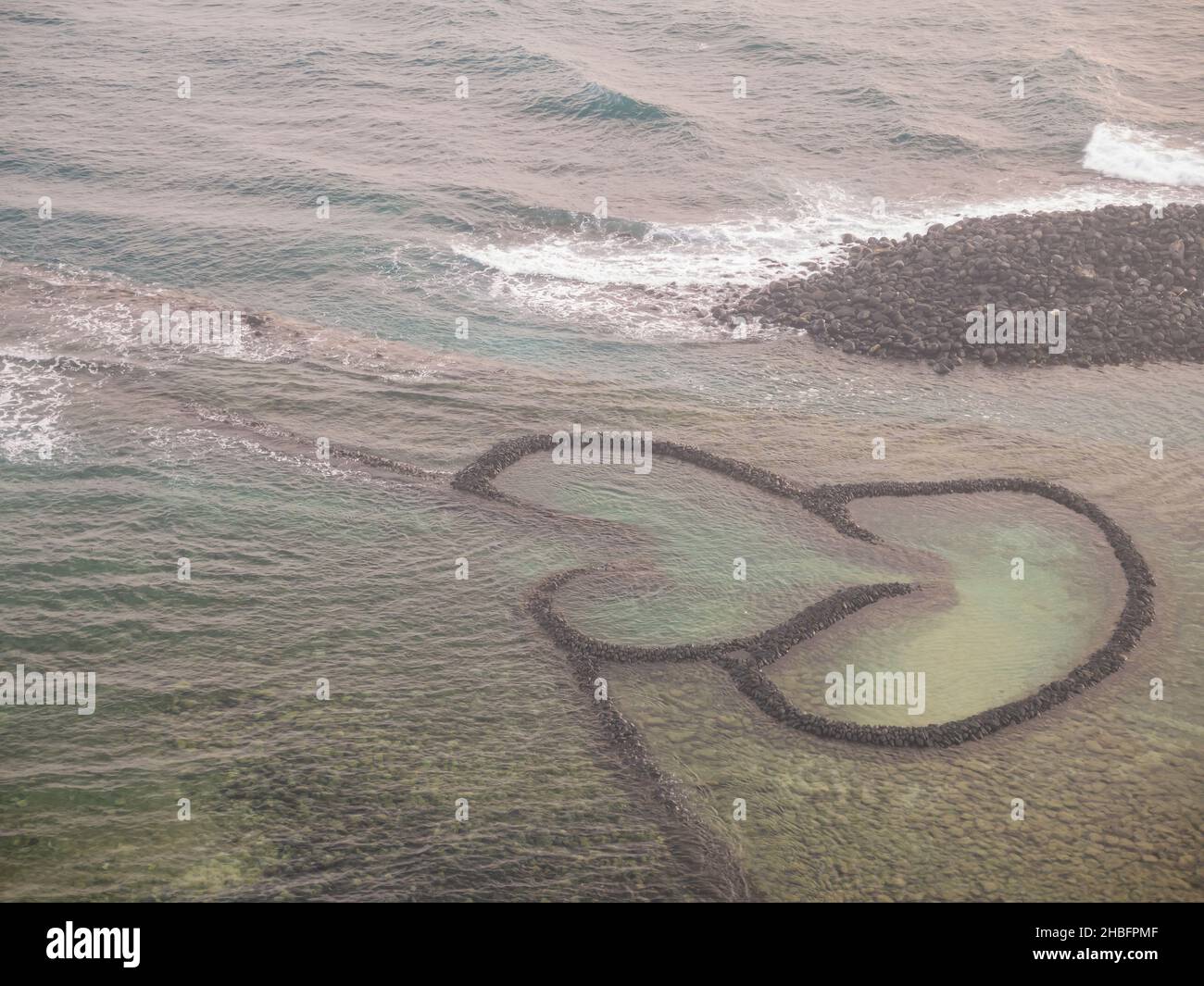 Twin Hearts Stone Weir in Penghu island at Taiwan Stock Photo - Alamy