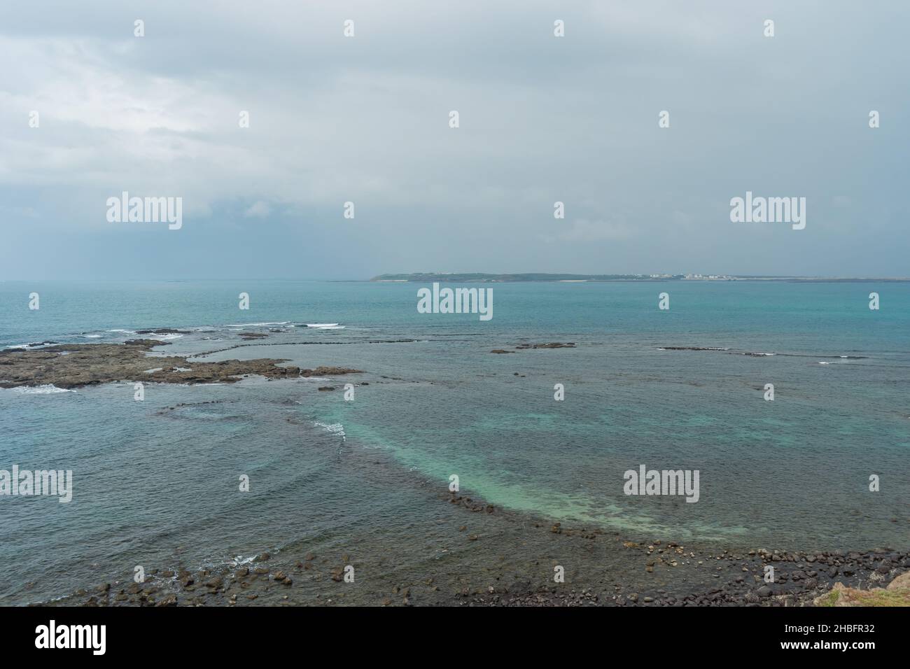 Twin Hearts Stone Weir cover in water at Penghu island, Taiwan Stock ...