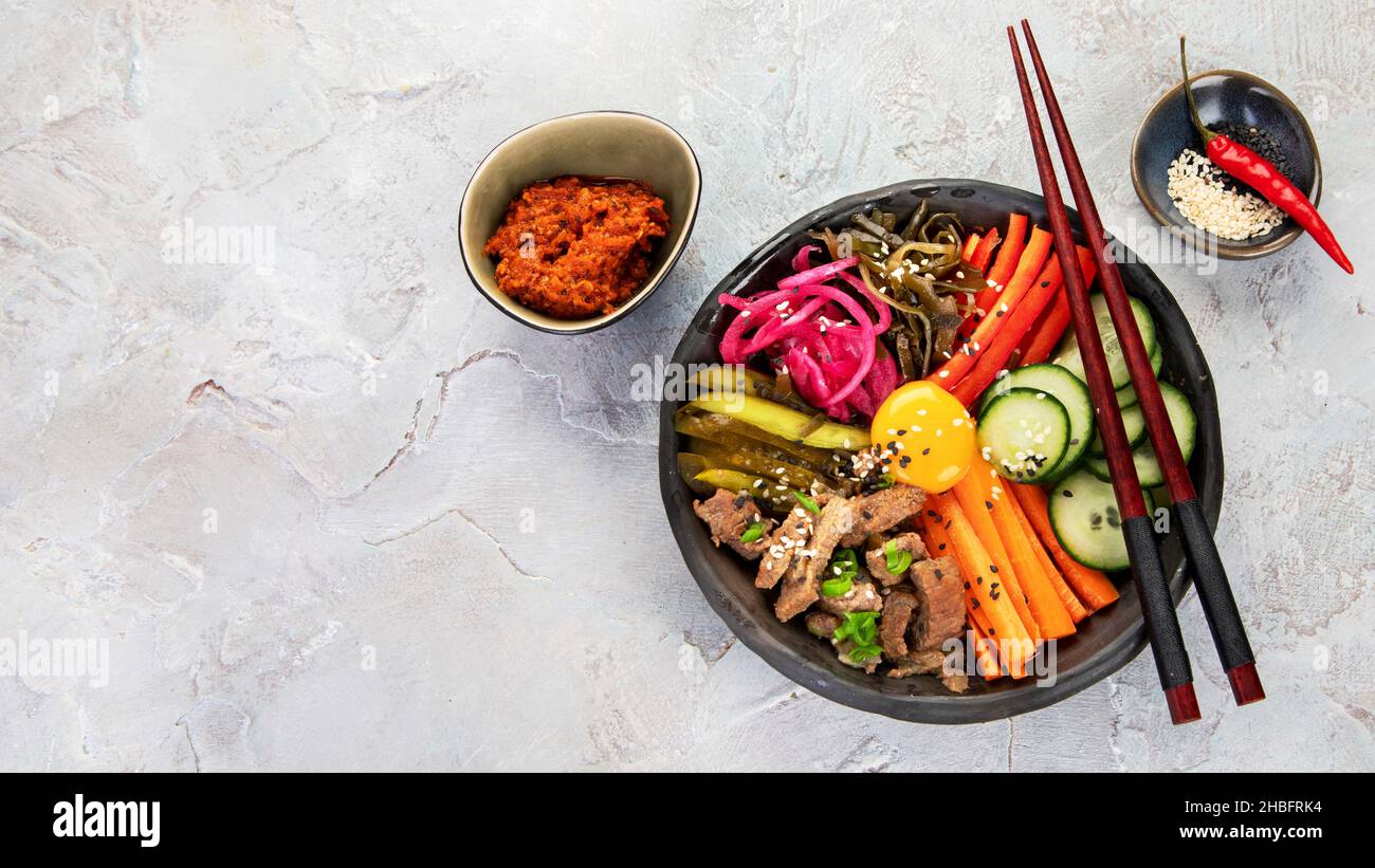 Bibimbap with snacks on gray background. Traditional Korean food. Top ...