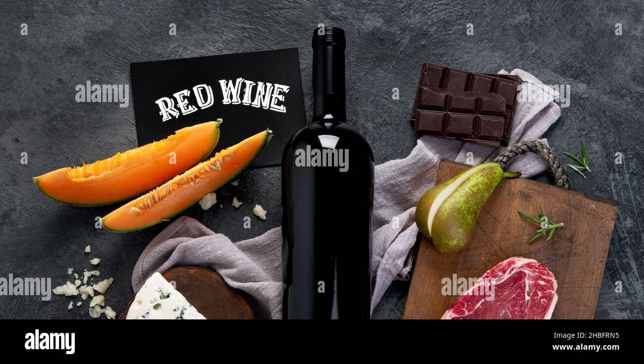 Red wine with appetizers on gray background. Traditional alcohol drinks ...