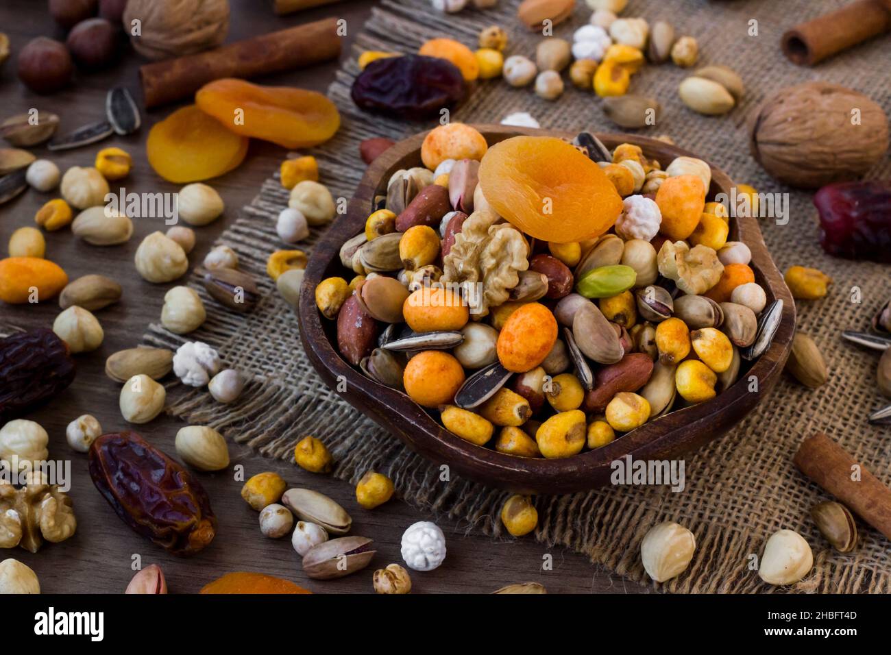 Mixed,crispy, dry nuts in a wooden plate on wooden table,with dried ...