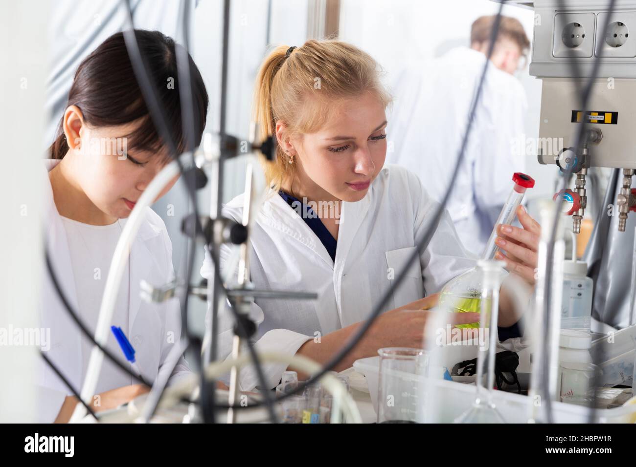Woman lab technician with female assistant working with reagents Stock ...