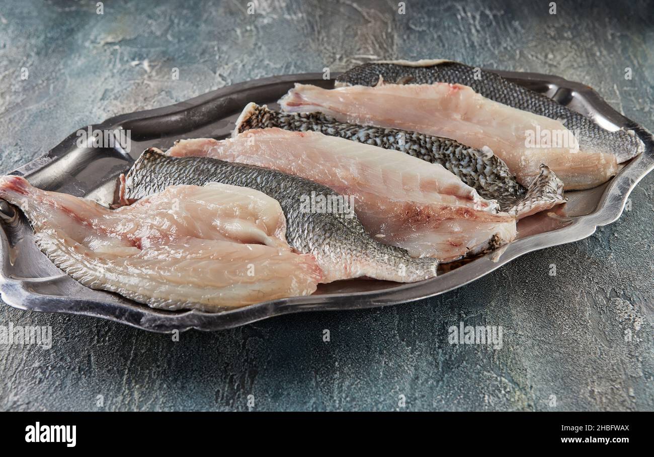 Fresh bass fish, ready to cook on tray Stock Photo - Alamy