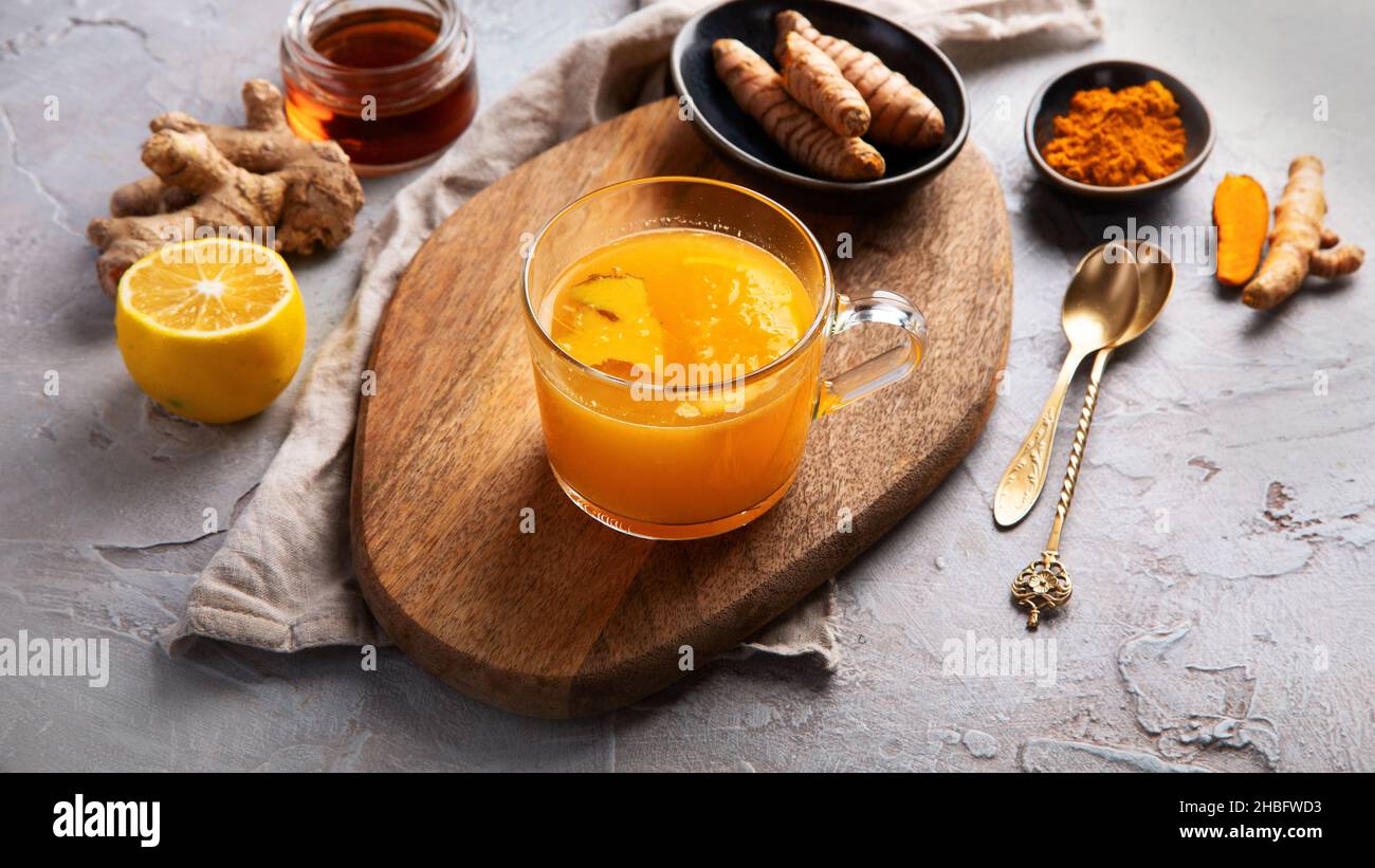 Healthy turmeric golden tea on light gray background. Indian ...