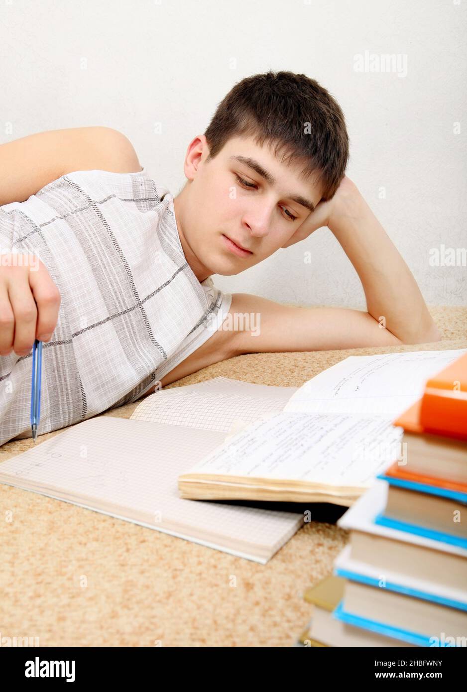 Teenager doing Homework on the Sofa at the Home Stock Photo - Alamy