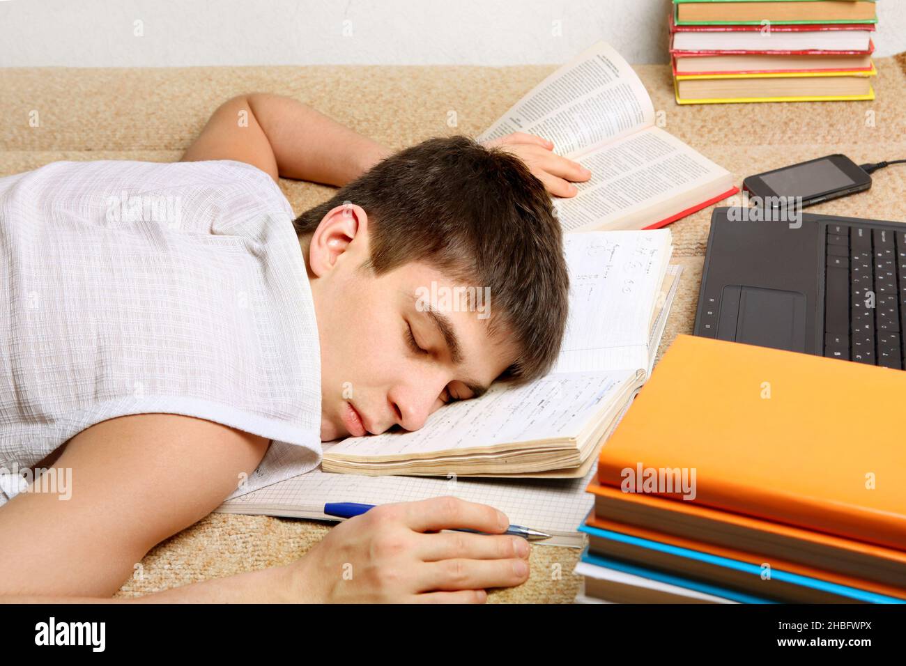 Tired Teenager sleeping on the Books at the Home Stock Photo - Alamy