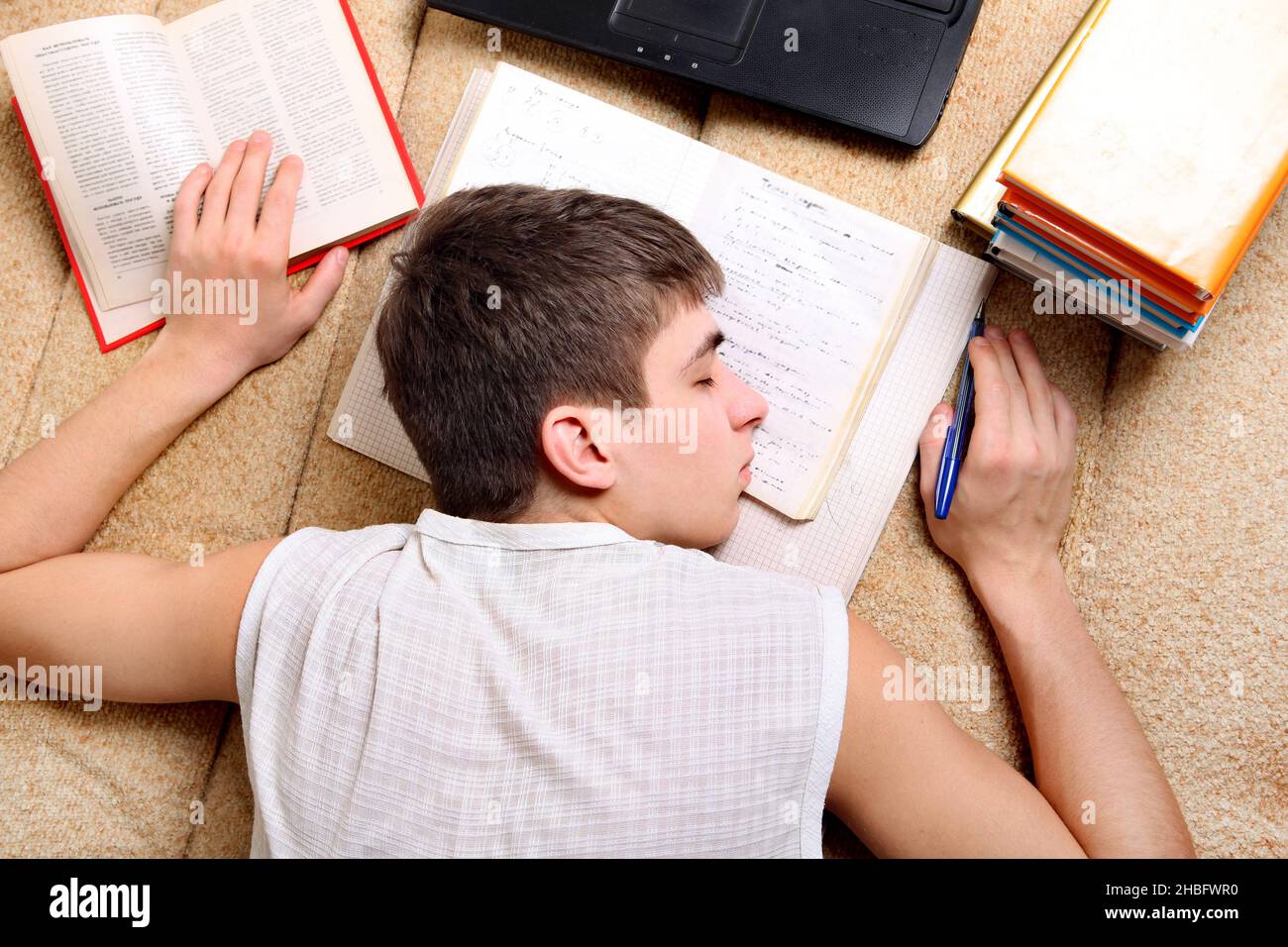 Upper view of Tired Teenager sleeping on the Books at the Home Stock ...