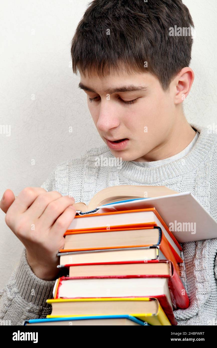 Teenager reads a Books on the Sofa at the Home Stock Photo - Alamy