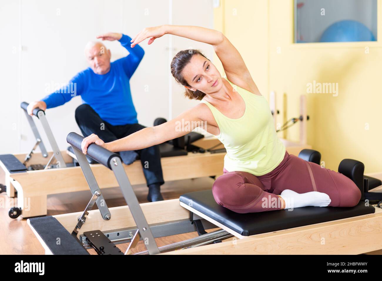 Pilates woman in reformer teaser exercise at gym Stock Photo - Alamy