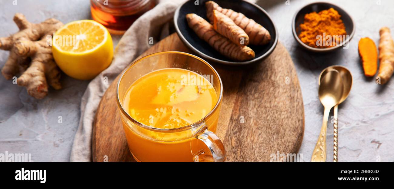 Healthy turmeric golden tea on light gray background. Indian ...