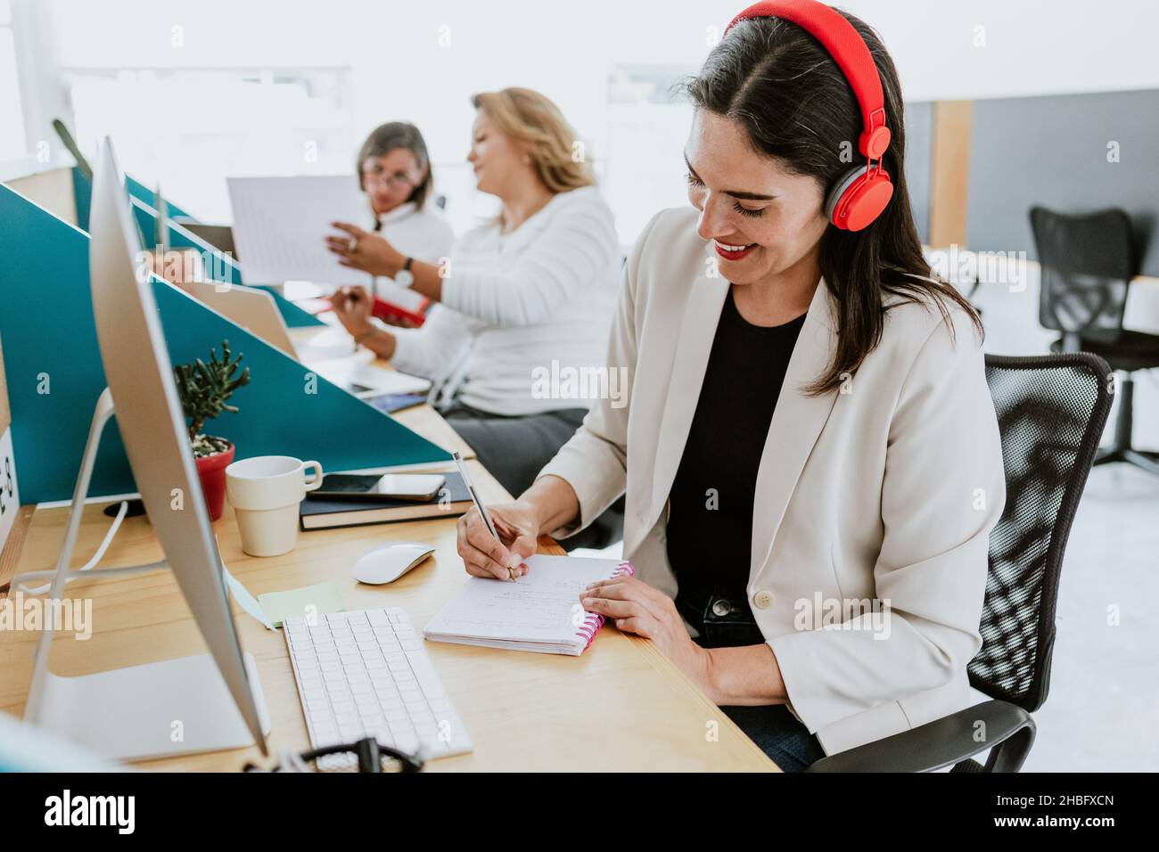 latin business adult woman working with computer at the office in ...