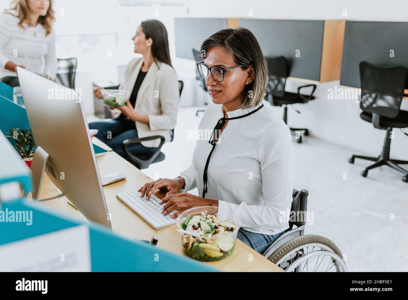 transgender latin woman working with computer at the office in Mexico ...