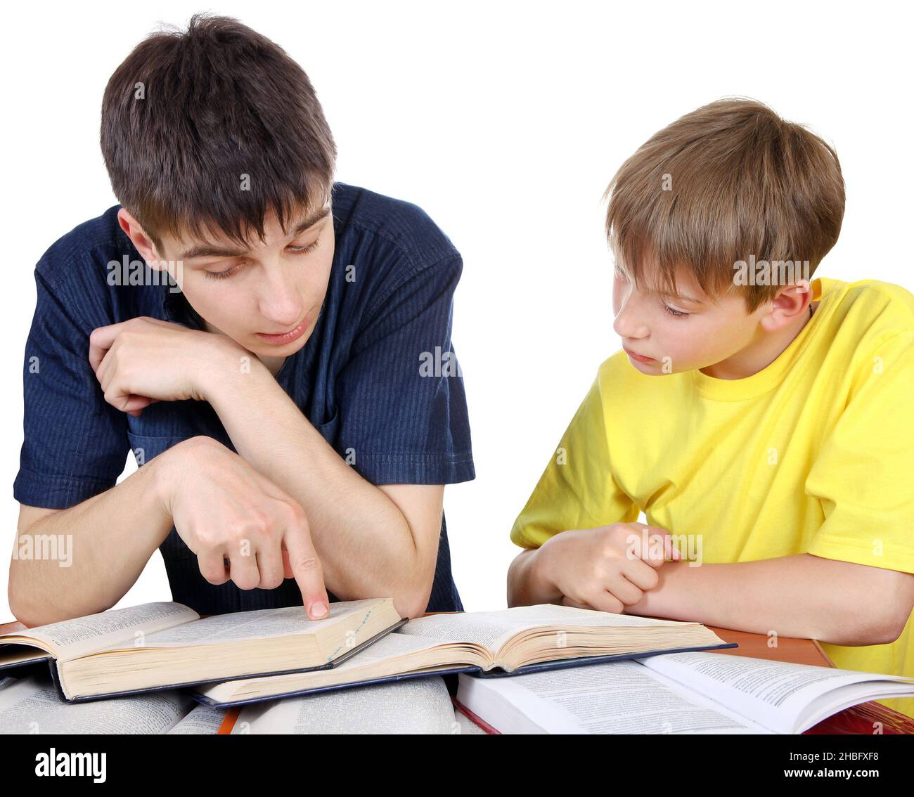 Older Brother helps Little Brother with a homework on the white ...