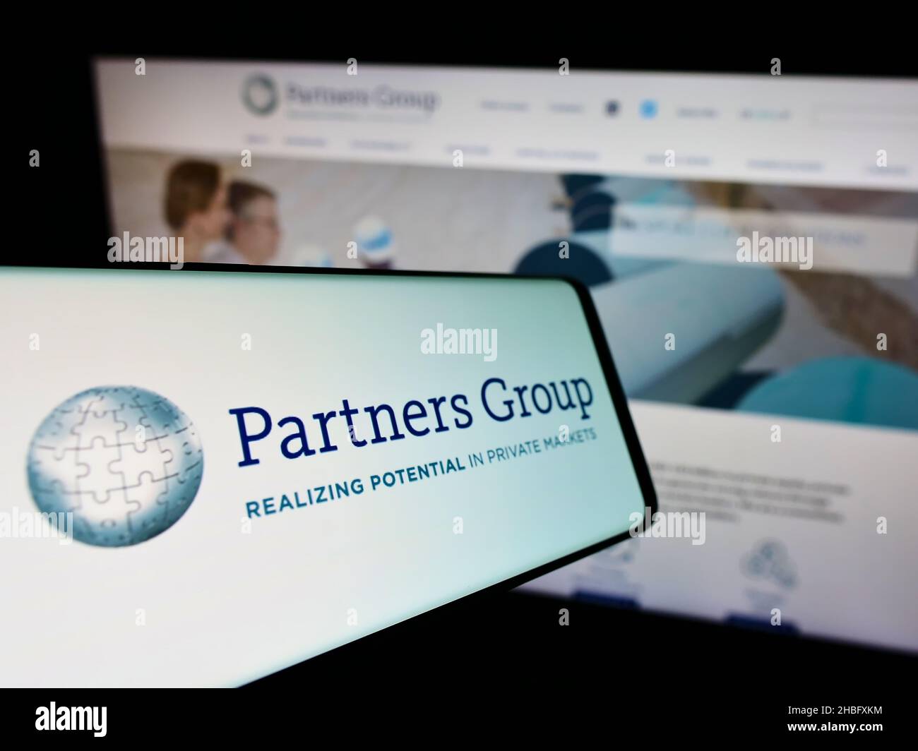 Mobile phone with logo of Swiss investment company Partners Group ...