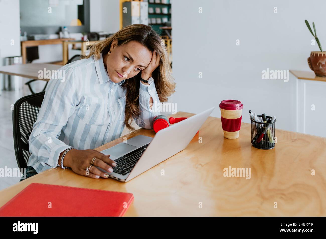 latin business adult woman working with computer tired and frustrated ...