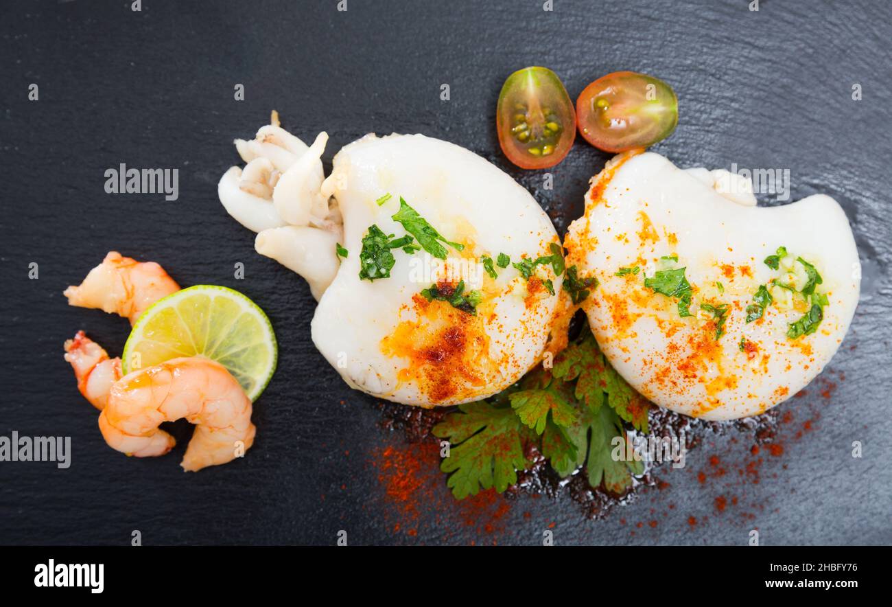 Roasted sepia served with shrimps Stock Photo - Alamy