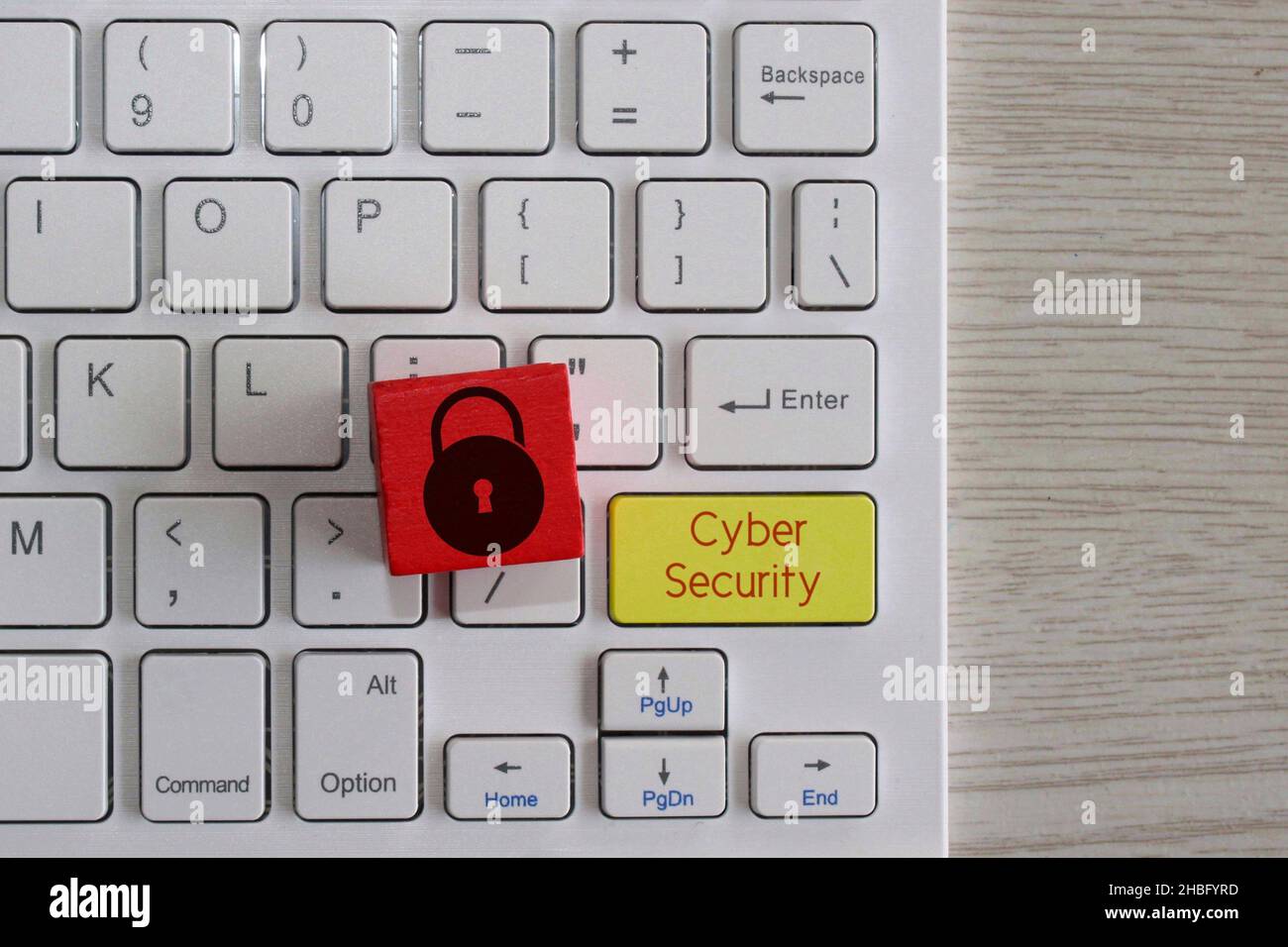 Cyber security concept. Red wooden cube with padlock icon on keyboard ...
