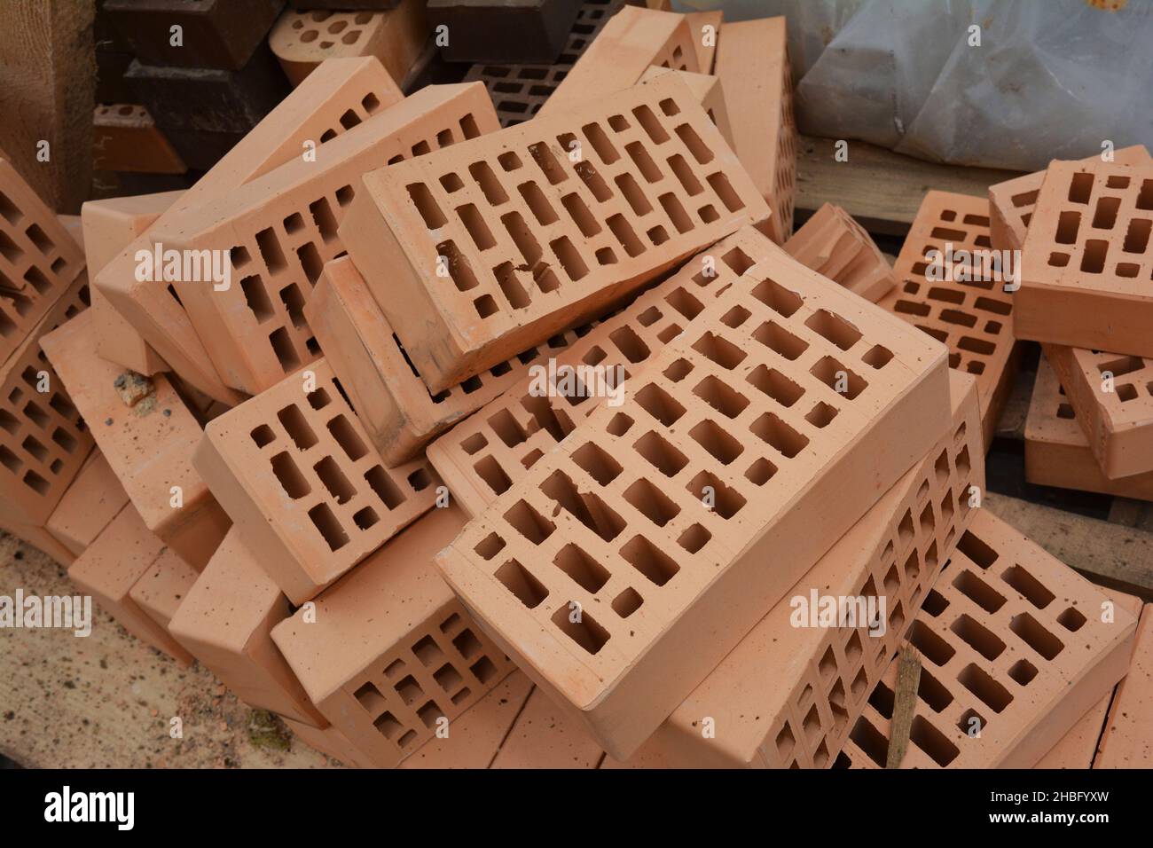 A pile of red perforated bricks, face ceramic bricks on the ...