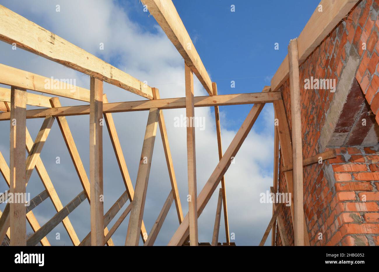 Roofing construction on the stage of roof framing. A close-up of wooden ...