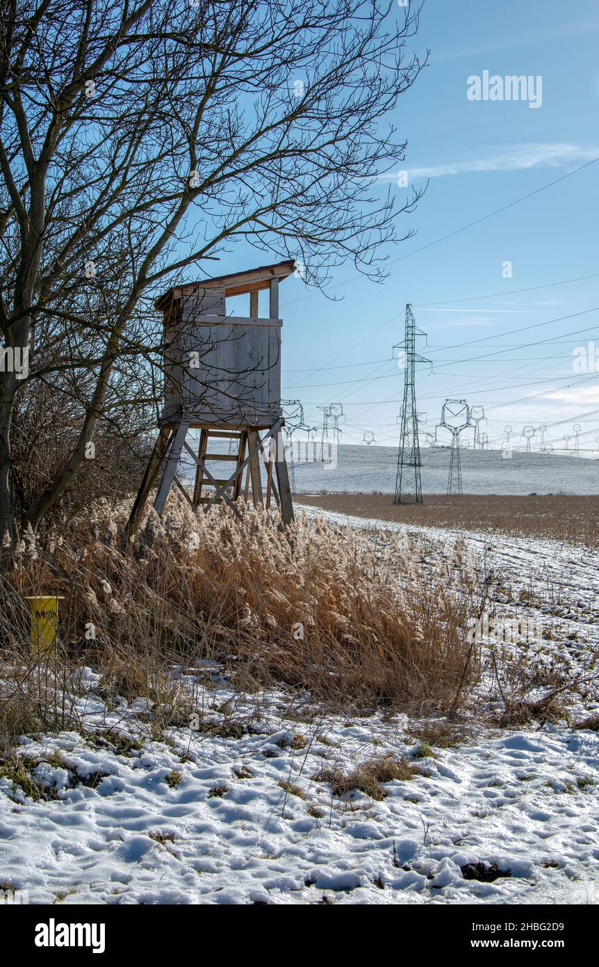 Wooden Hunt tower near the agricultural field in the winter. Huntsman ...