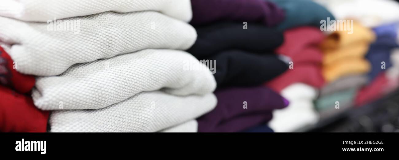 Folded clothes lying on store shelf closeup Stock Photo - Alamy