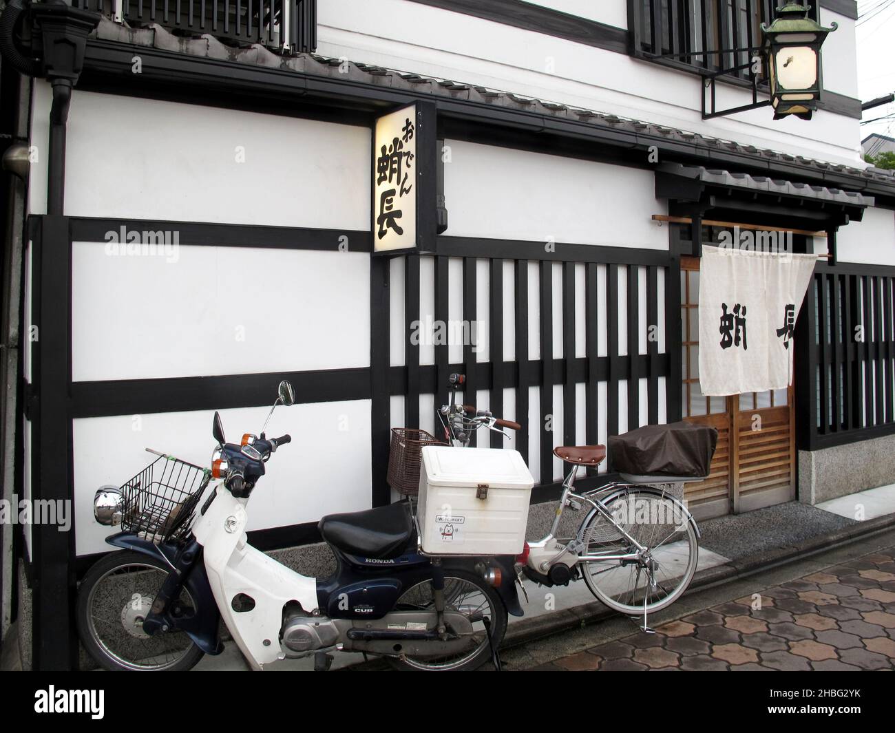 Japanese people riding motorcycle scooter and biking vintage bicycle ...