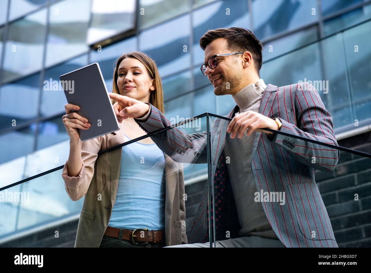 Two creative business people working on social media strategy using a ...