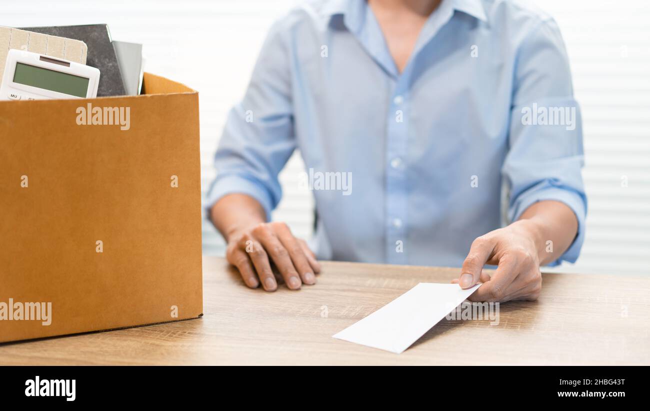 Resignation Concept The male officer sitting, putting his box of his ...