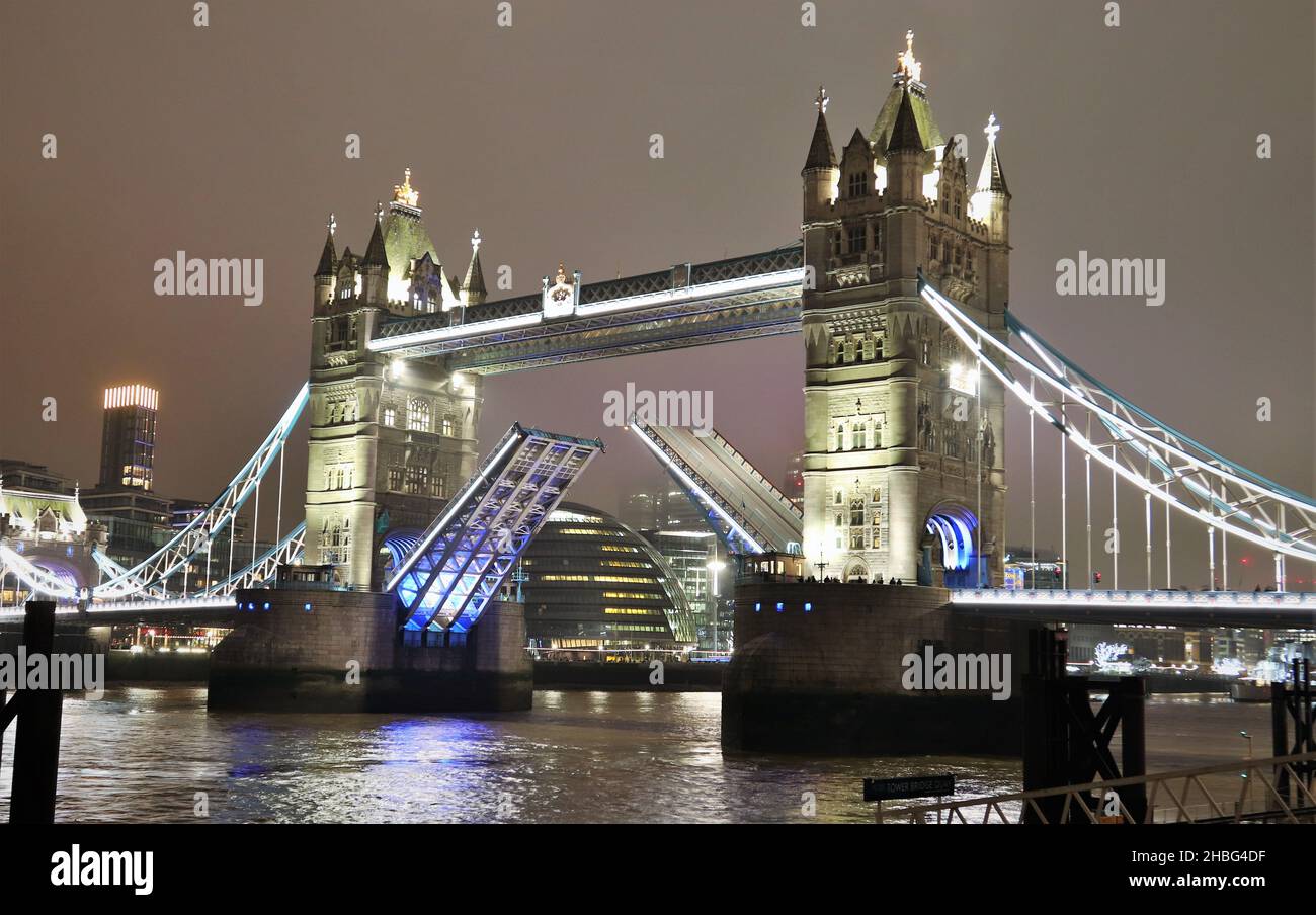 Tower bridge raised at night Stock Photo - Alamy