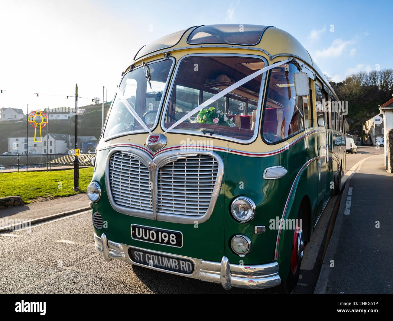 A 1956 Bedford vintage wedding coach parked in a bus stop in Porthleven ...