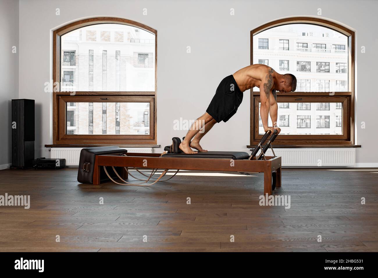 Pilates reformer workout exercises man at gym indoor Stock Photo - Alamy