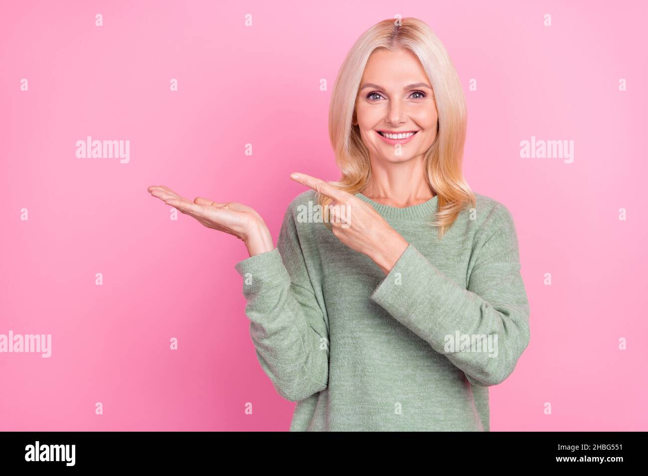 Photo of charming cute lady pensioner dressed green pullover holding ...