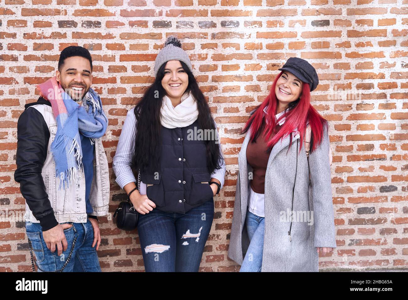 Positive multiracial young male and female friends wearing trendy ...