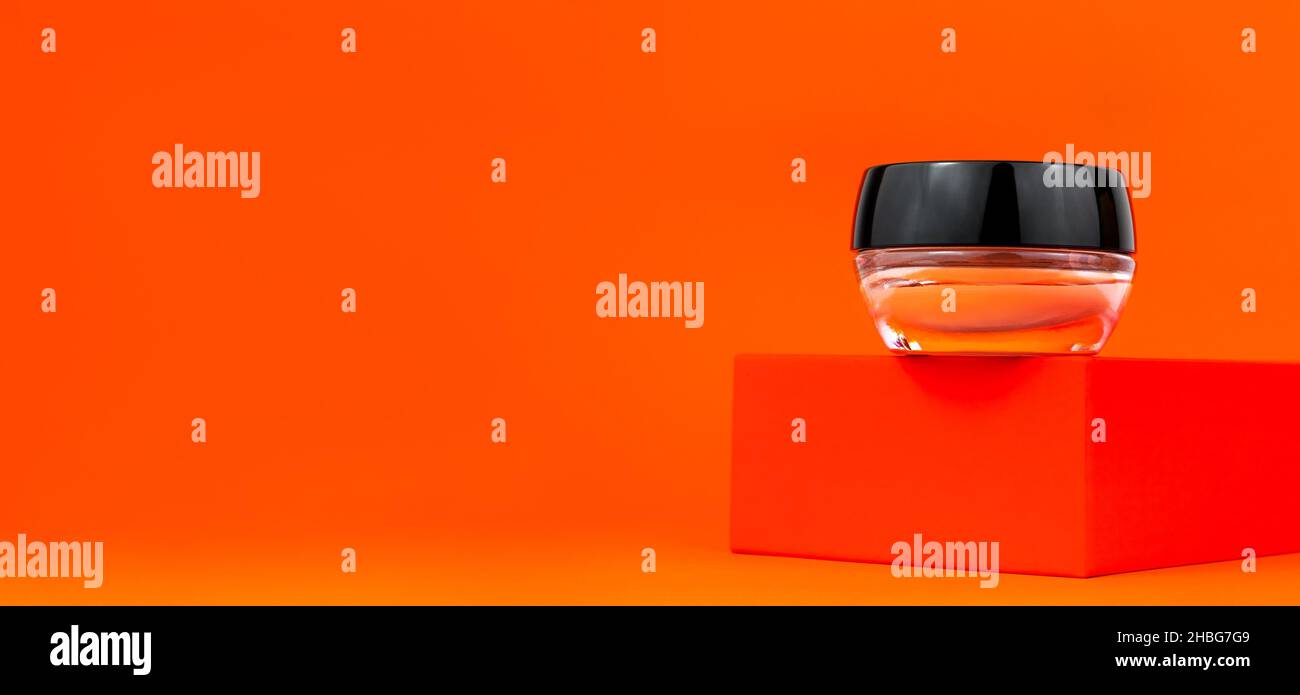 Cosmetic tonal foundation glass jar mockup on geometrical podium orange ...