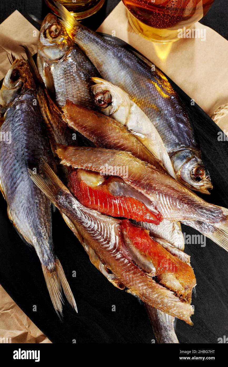 Whole and skinned salted air-dried roach with roe served with amber ...