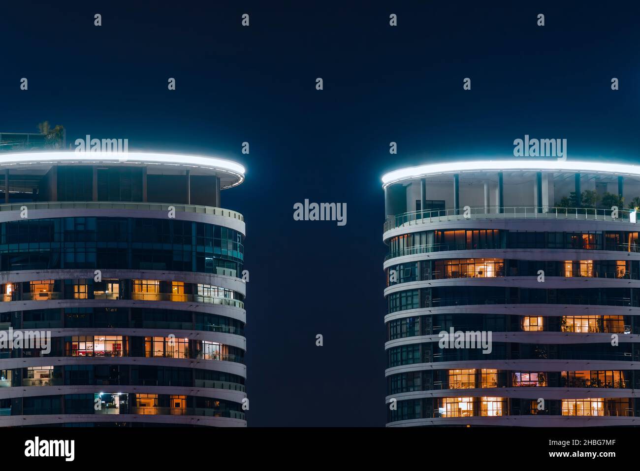 Glass facade of modern city high rise, buildings show lighting using by ...