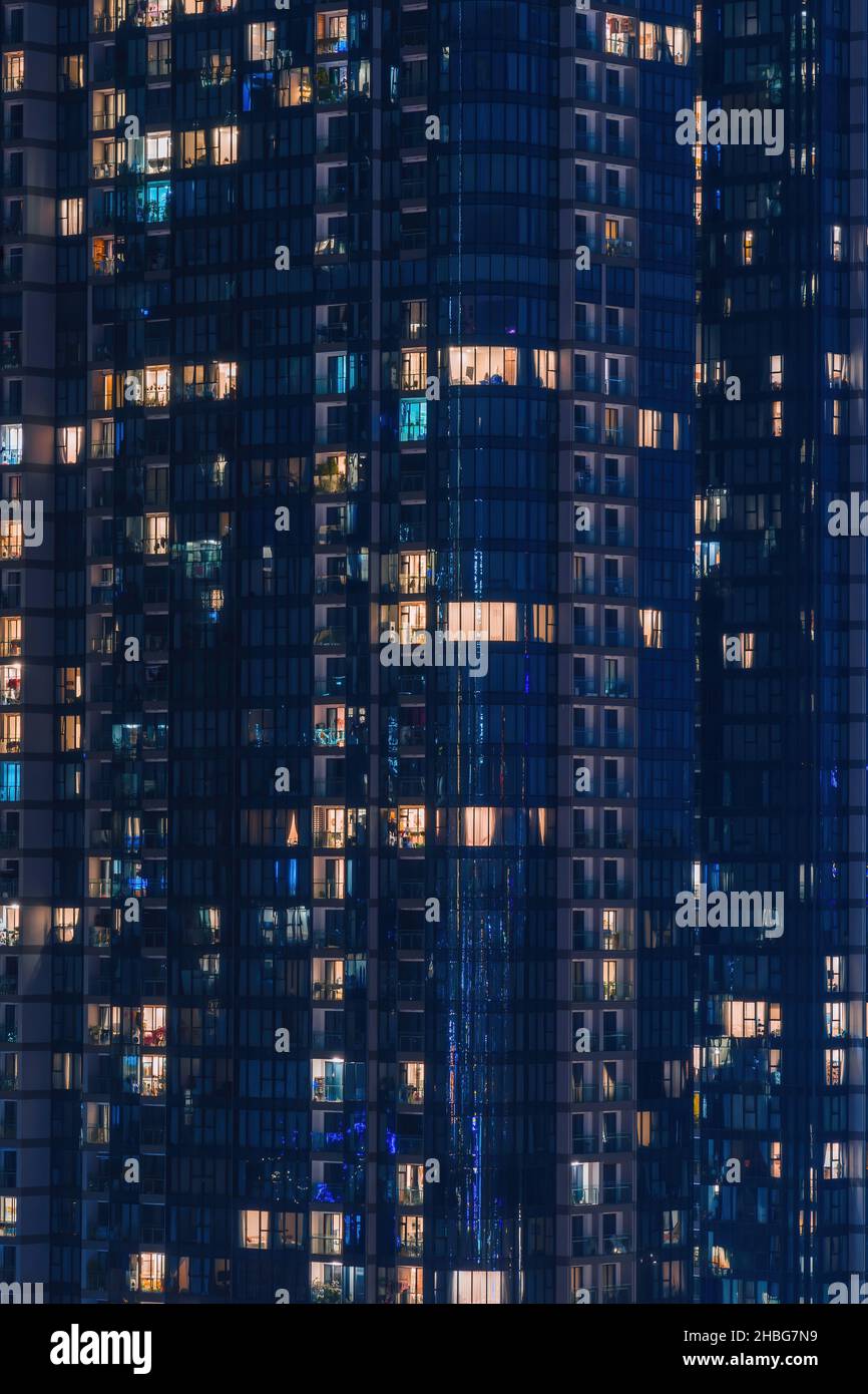 Glass facade of modern city high rise, buildings show lighting using by ...
