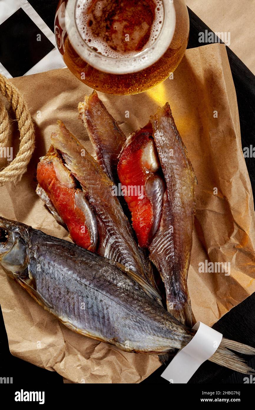 Whole and skinned salted air-dried roach with roe served on wrapping ...