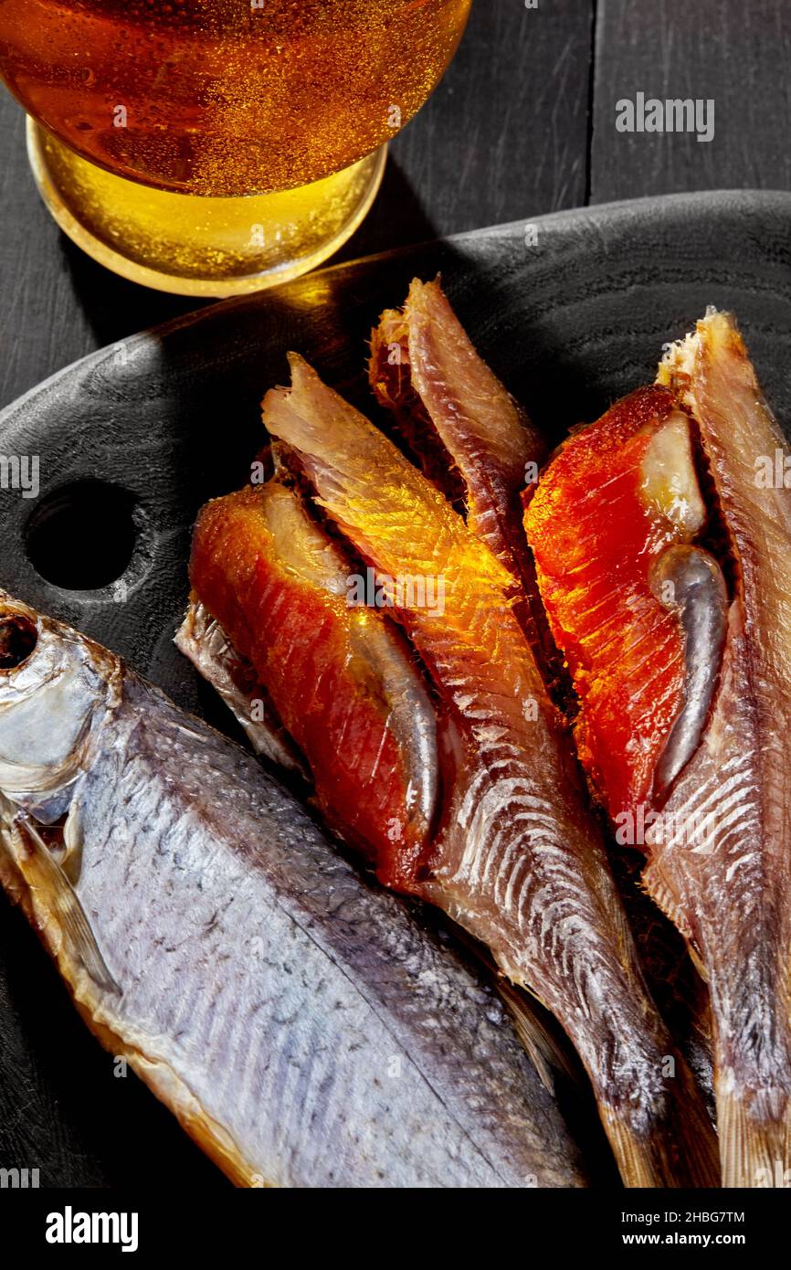 Closeup of whole and skinned salted air-dried roach with roe served ...