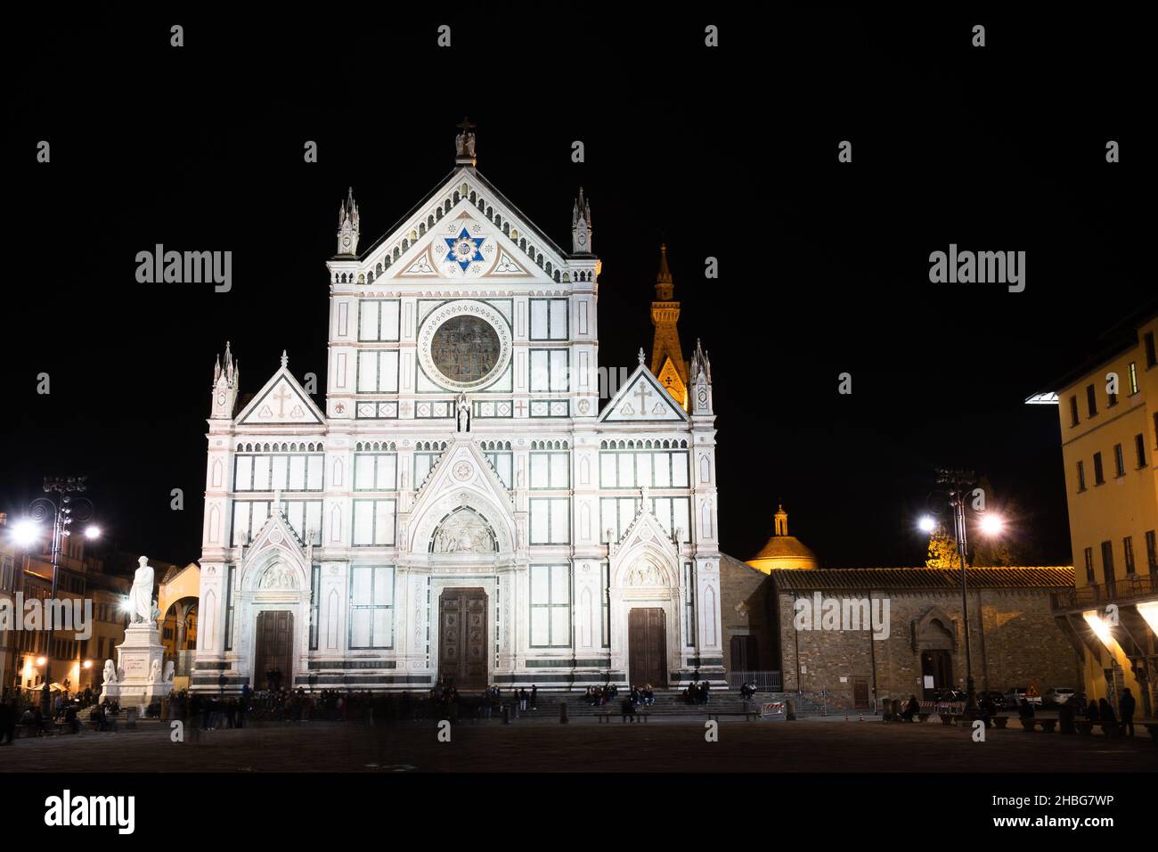 The lighting facade of the basilica of Santa Croce with a background of ...